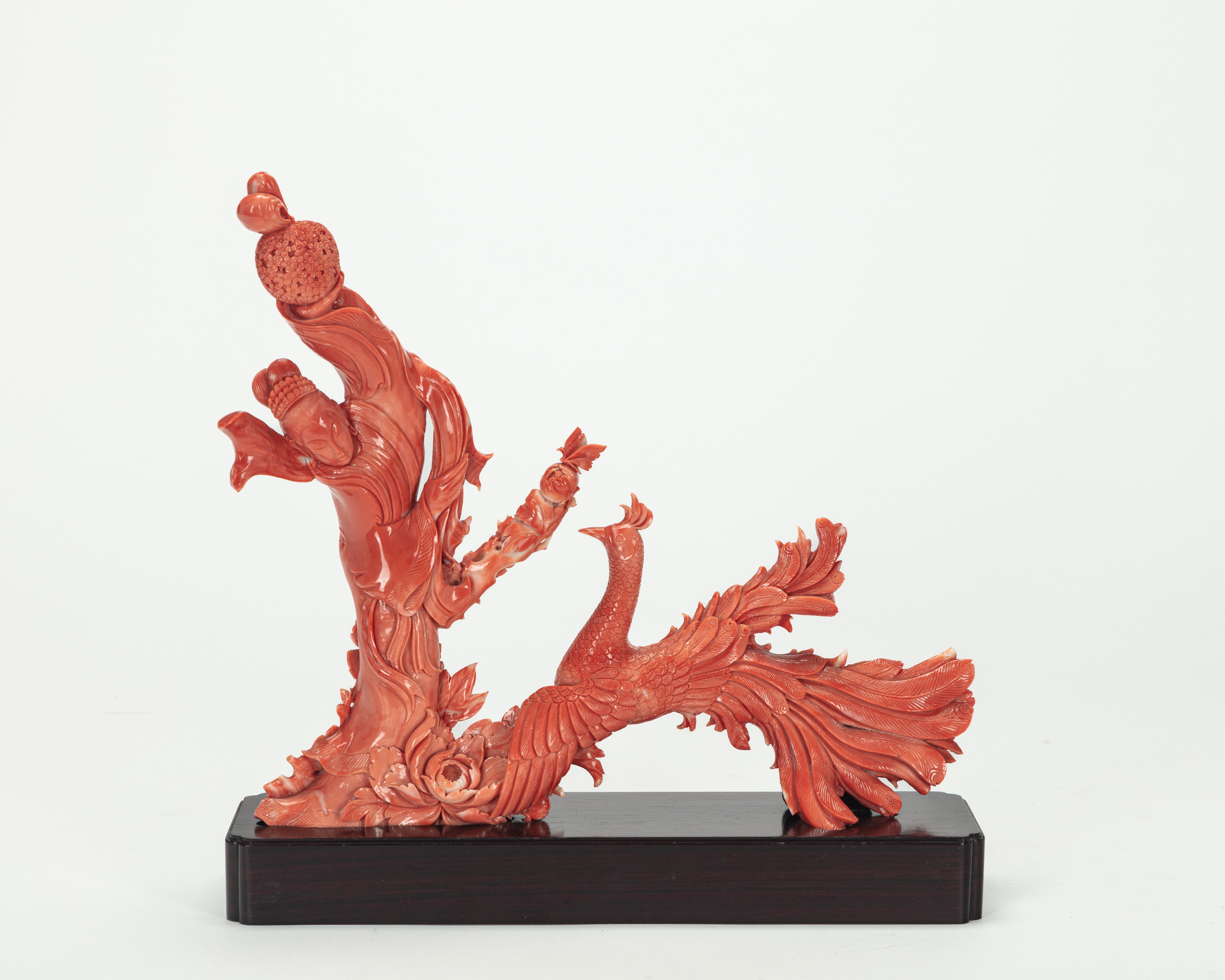 Carved coral sculpture depicting a lady in a thousand dresses with a ...
