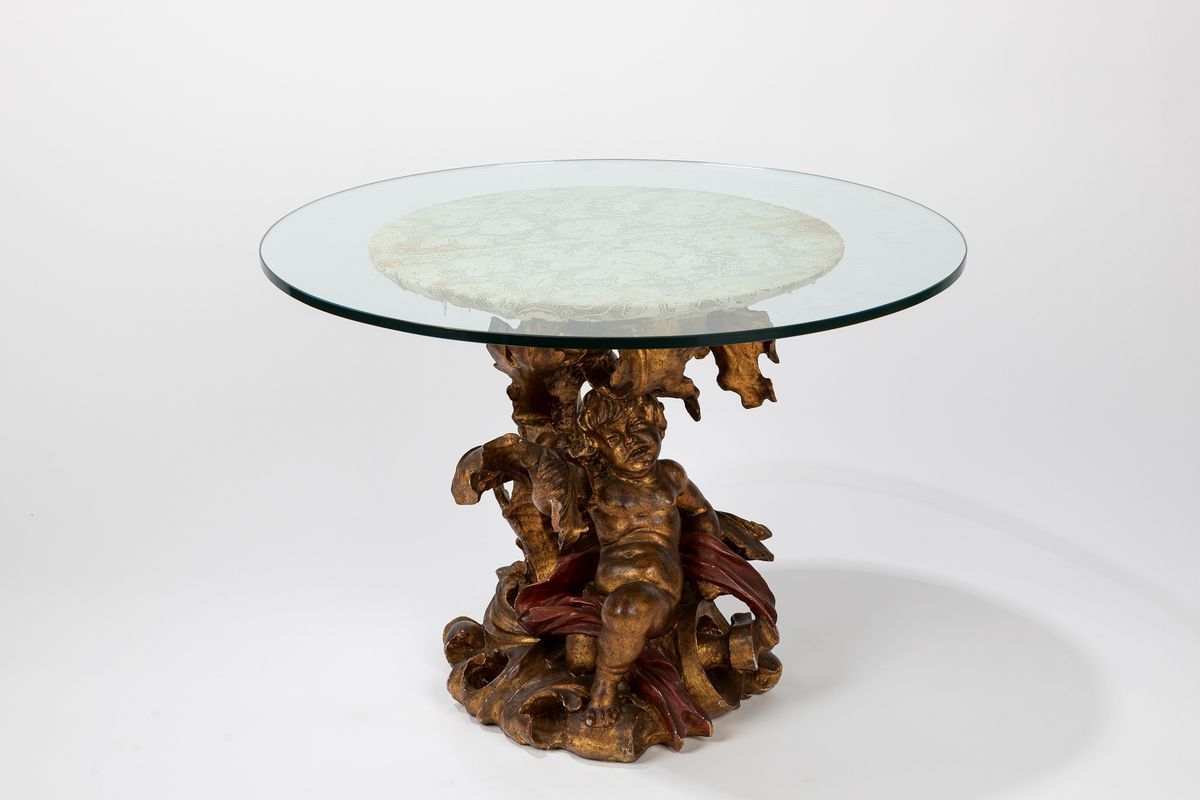 Coffee table composed of a richly carved and gilded wooden base and a ...